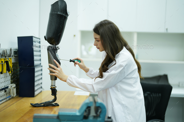 Orthopedic technician making prosthetic leg for disabilities people in workshop. Stock Photo by ...